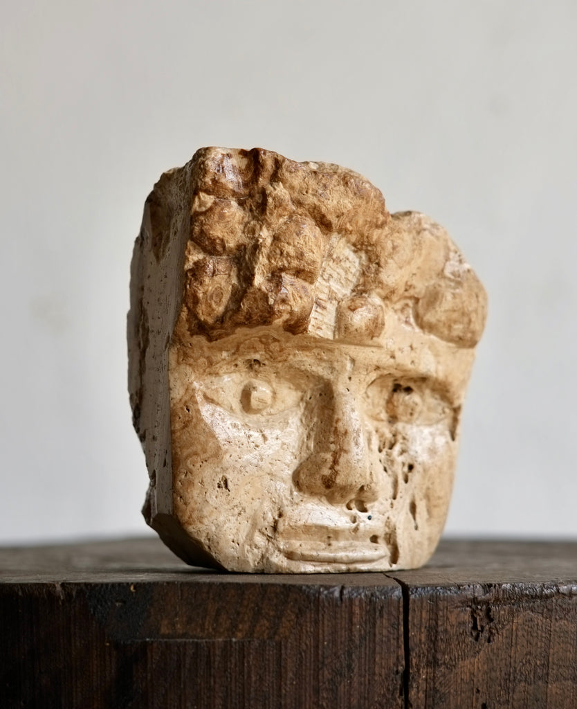 Italian Carved Stone Face – punch the clock