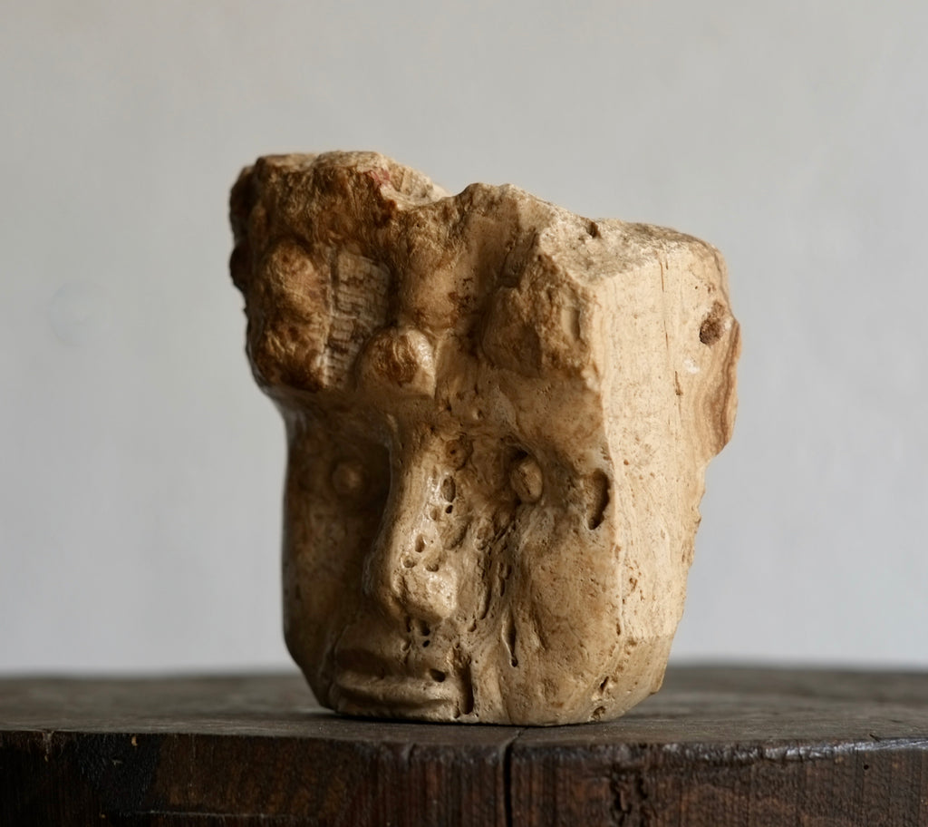 Italian Carved Stone Face – punch the clock